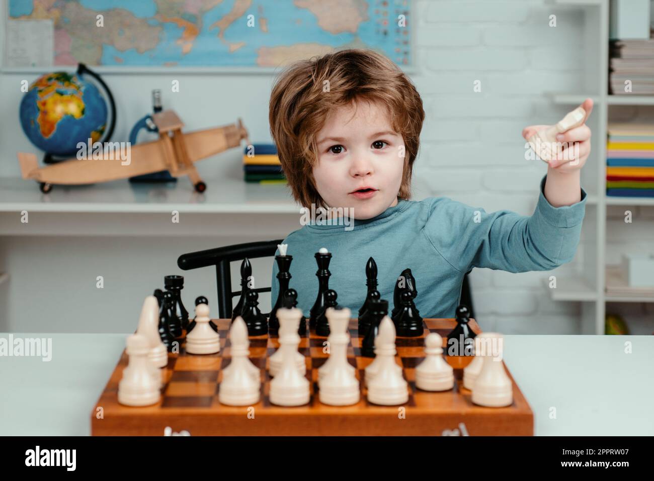 Little boy playing chess. Kids educational games, early development ...