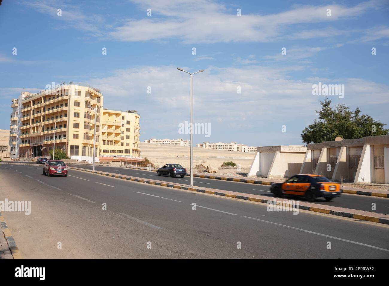 Egyptian road with cars and taxi passing Stock Photo - Alamy