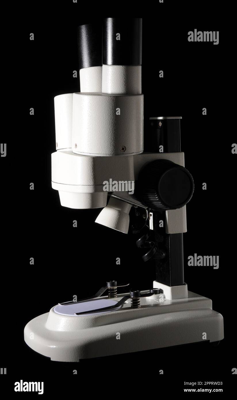Dual stage microscope isolated over black Stock Photo - Alamy