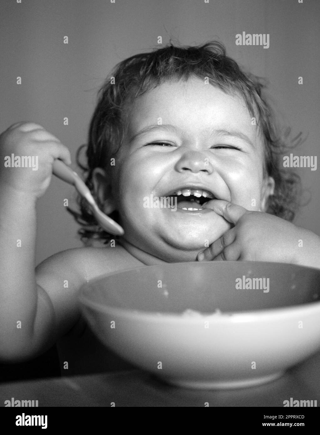 Happy child eating delicious dessert Black and White Stock Photos ...