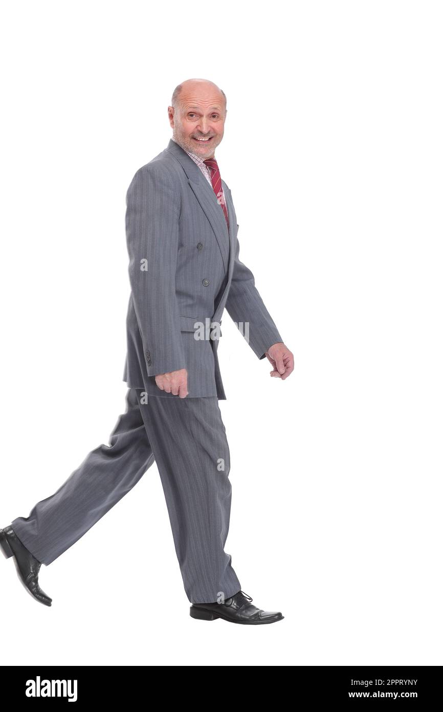 side view full length photo of a mid aged business man walking forward ...