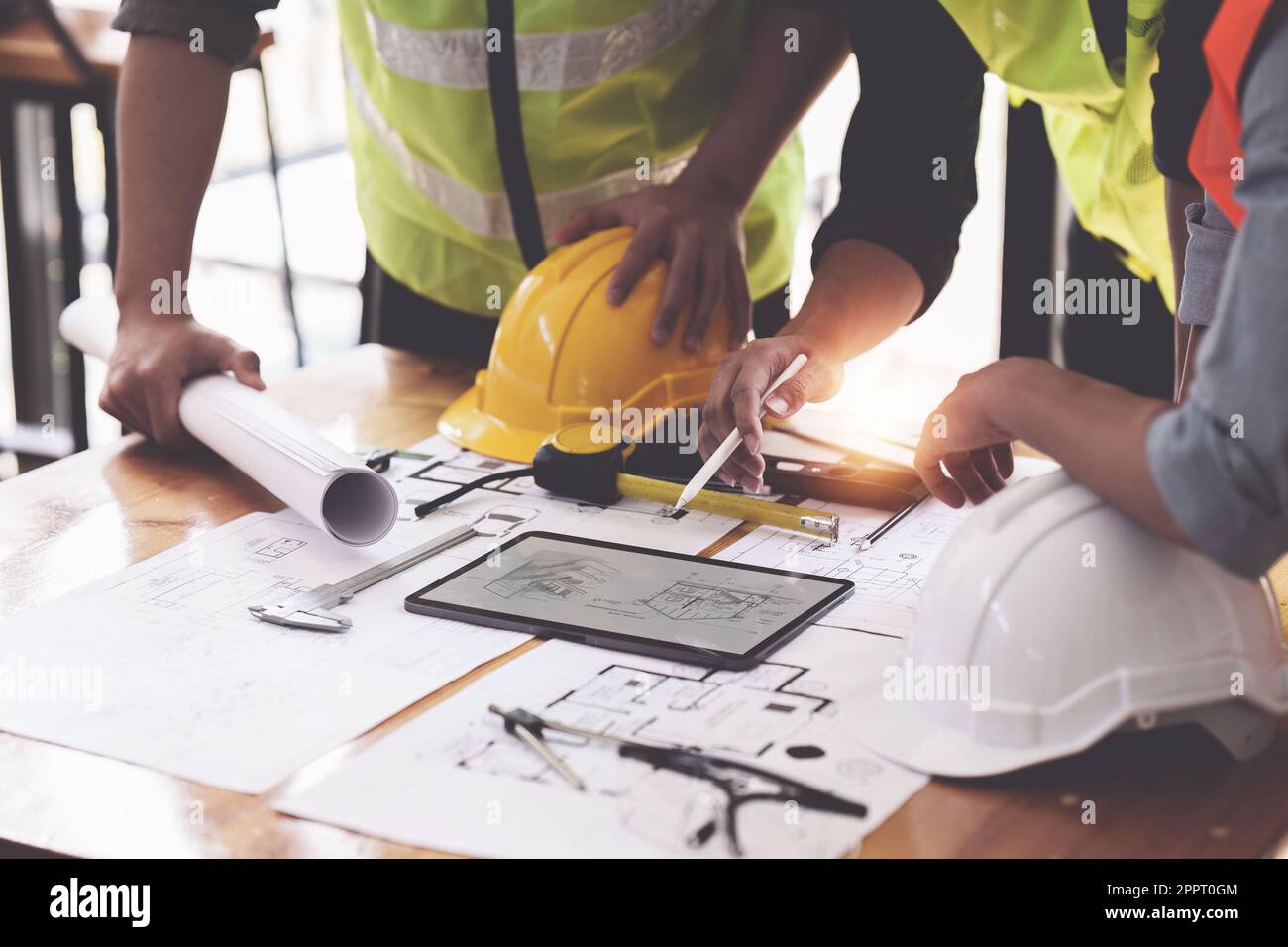 Architect And Engineer Working With Blueprints For Architectural Plan