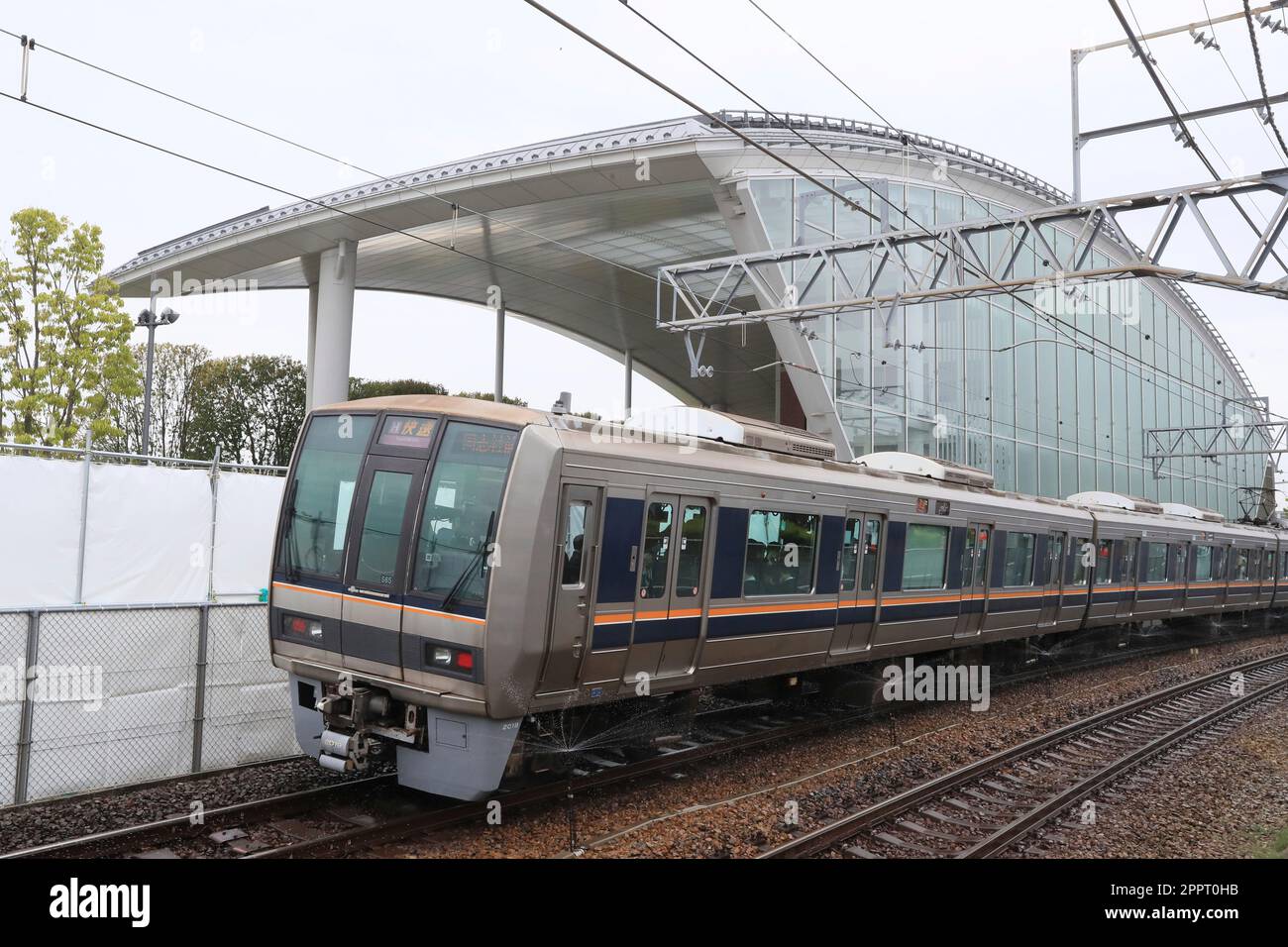 A train passes near the site of the derailment accident in Amagasaki City, Hyogo Prefecture on ...
