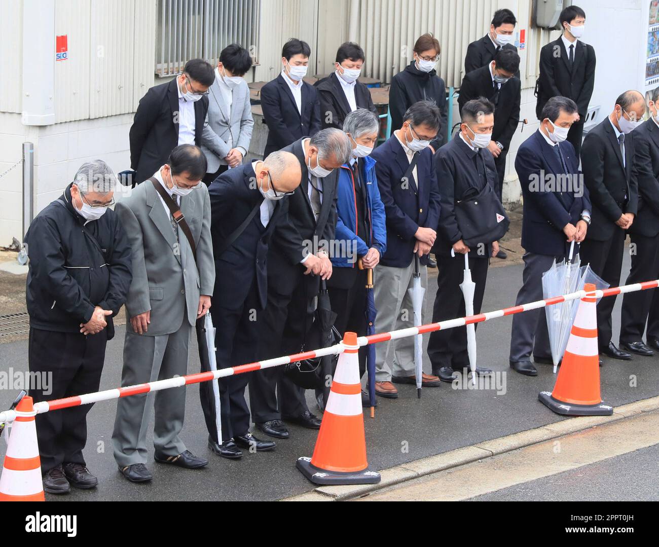 West Japan Railway Company employees mourn for victims near the site of the derailment accident ...