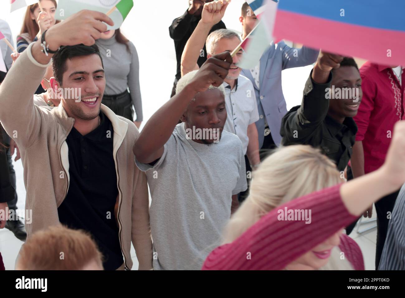 group of different people with their national flags striding forward ...