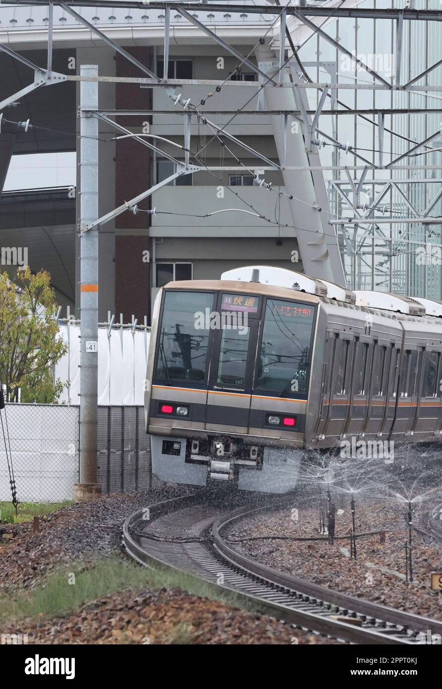 A train passes near the site of the derailment accident in Amagasaki City, Hyogo Prefecture on ...