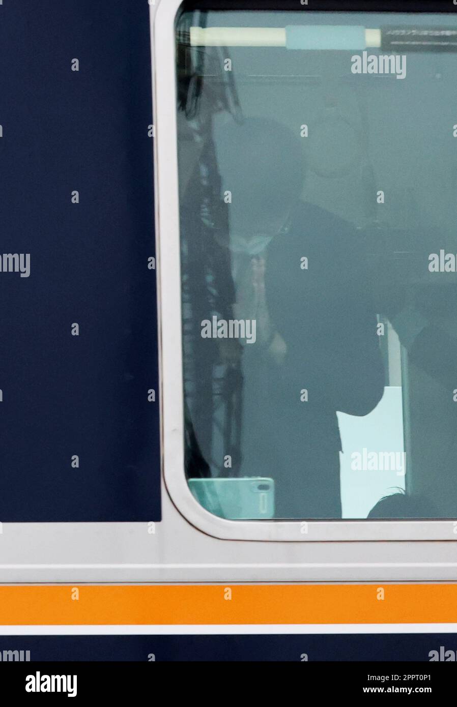 A passenger mourns for victims while passing near the site of the derailment accident in ...