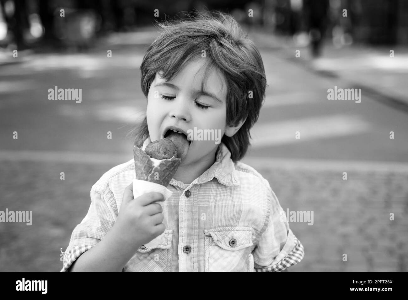 Kids junk food. Child eating ice cream outdoor. Delicious summer snacks ...