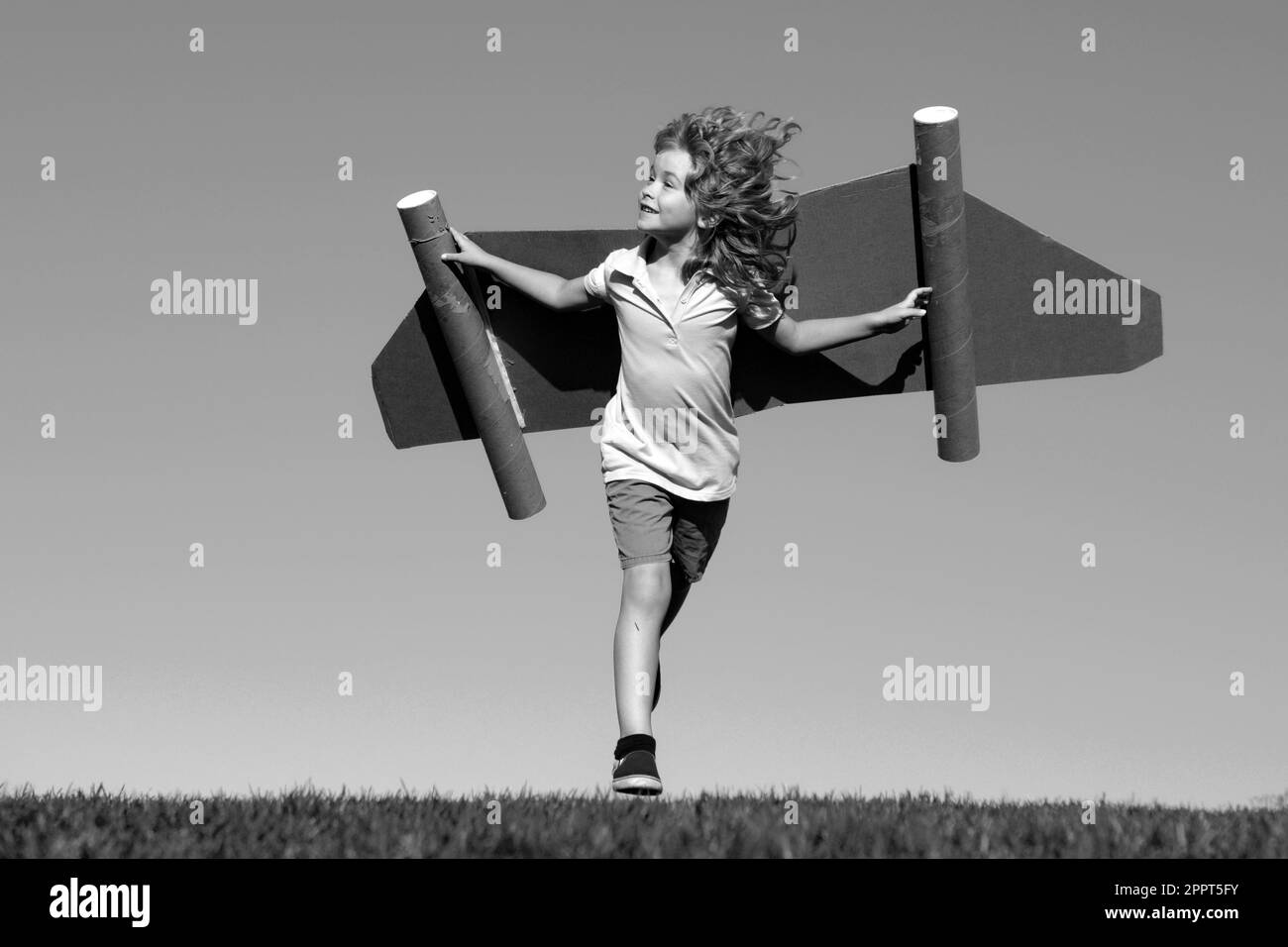 Little child plays astronaut or pilot. Child running on the background ...