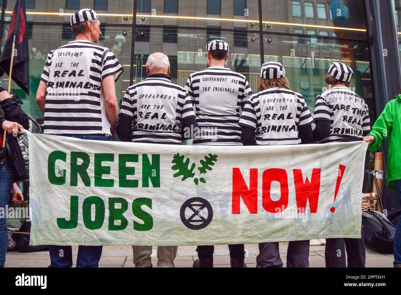 London, UK. 24th Apr, 2023. Protesters dressed in prison costumes with ...