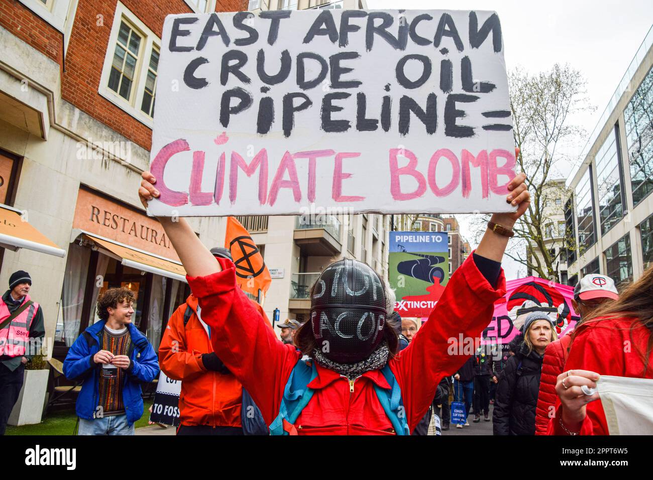 London, UK. 24th Apr, 2023. A protester wearing a Stop EACOP (East ...