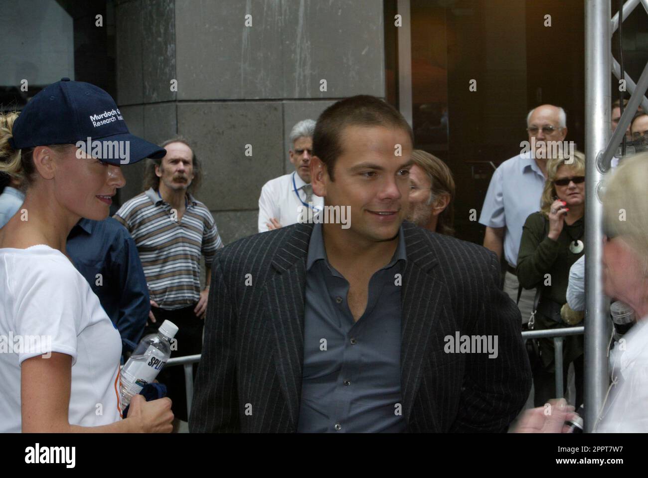 Lachlan Murdoch walks a perspirating Sarah Murdoch to the Westin Hotel ...