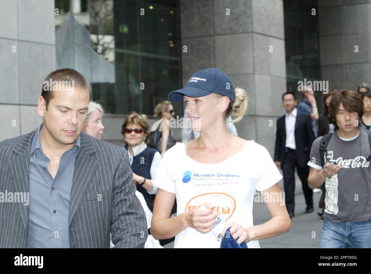Lachlan Murdoch walks a perspirating Sarah Murdoch to the Westin Hotel ...