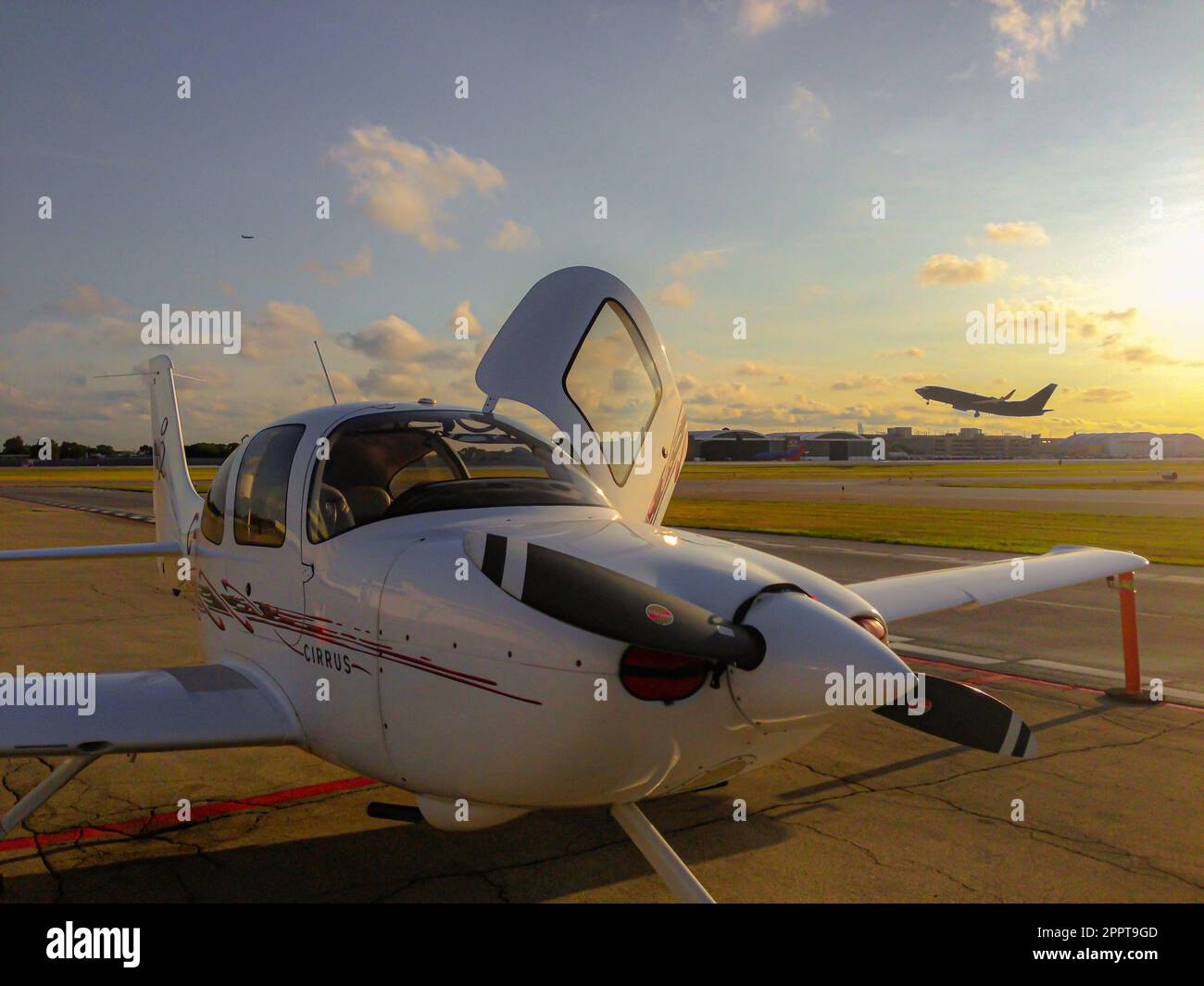 Cirrus SR20 parked on the ramp at Midway Field in Chicago. A 767 taking ...