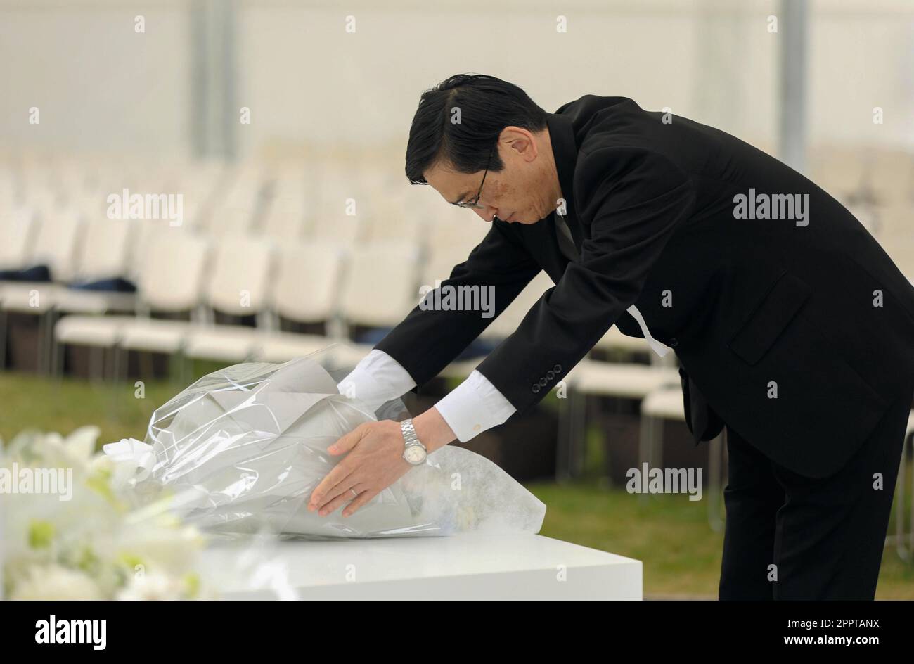 West Japan Railway Co. President Kazuaki Hasegawa offers flowers at a memorial built at the site ...