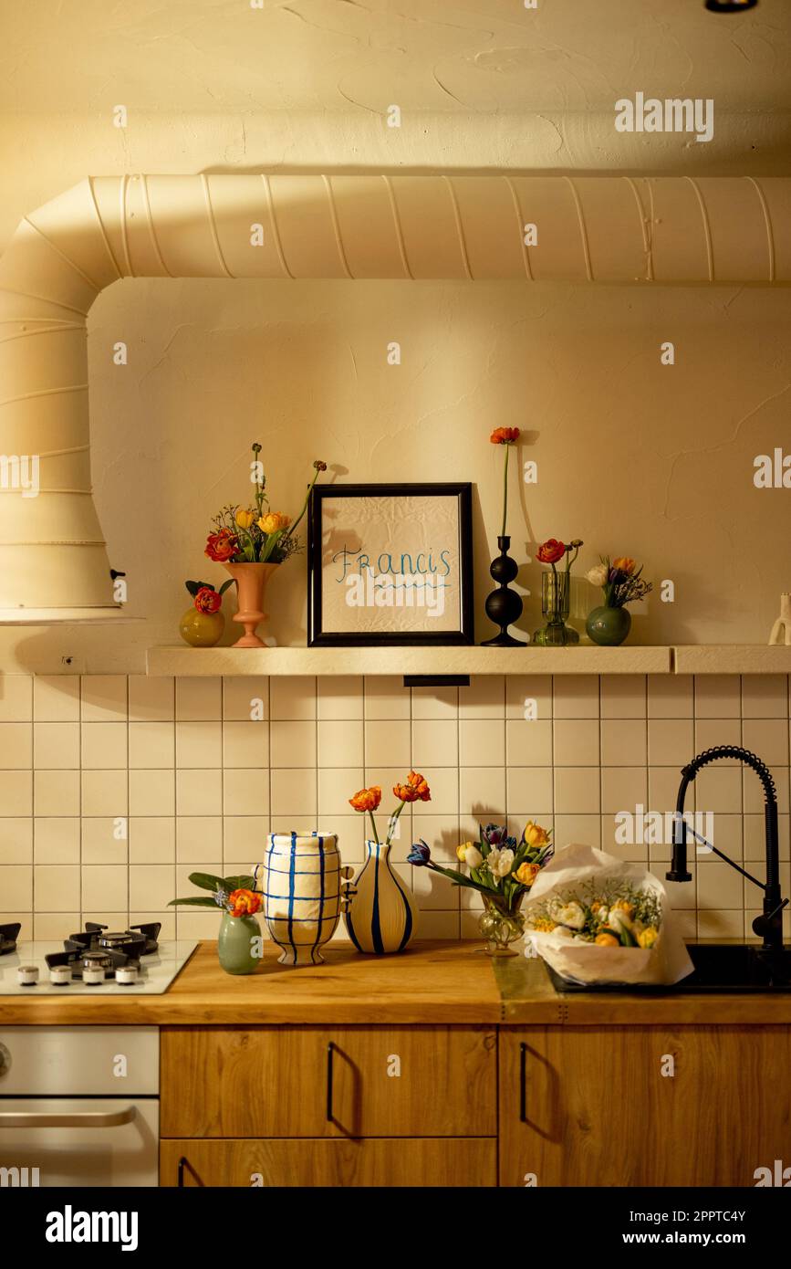 Modern kitchen interior decorated with flowers Stock Photo - Alamy