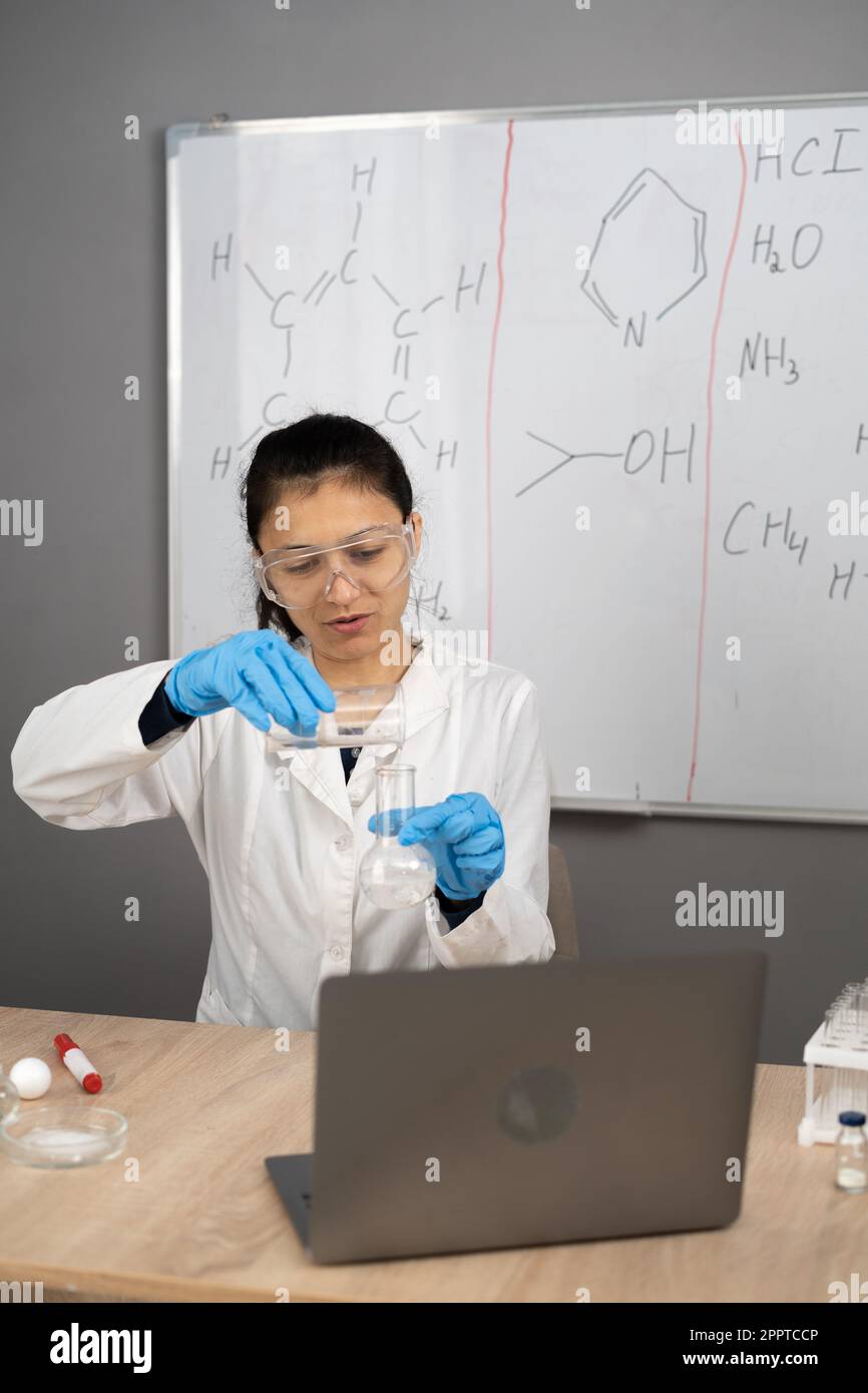 Online remote learning. Teacher with laptop computer having video ...