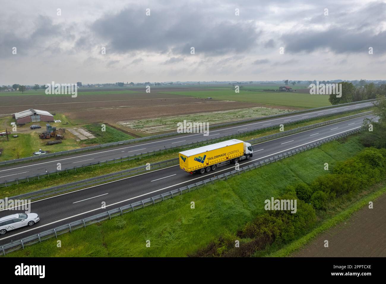 Piacenza, Italy - April 2023 Cargo trucks and cars in the motorway a1 ...