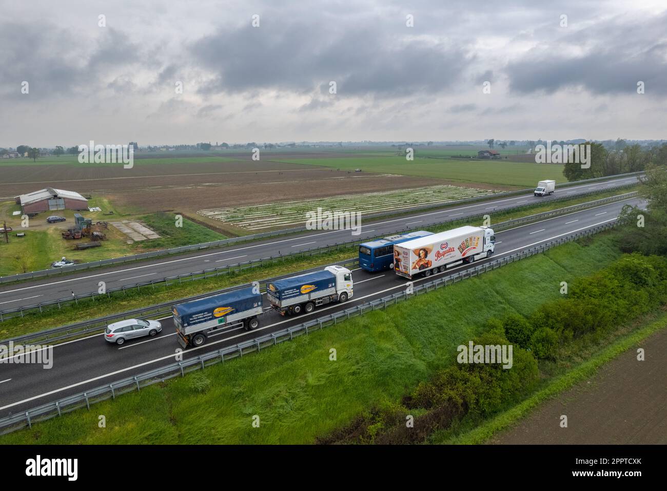 Piacenza, Italy - April 2023 Cargo trucks and cars in the motorway a1 ...