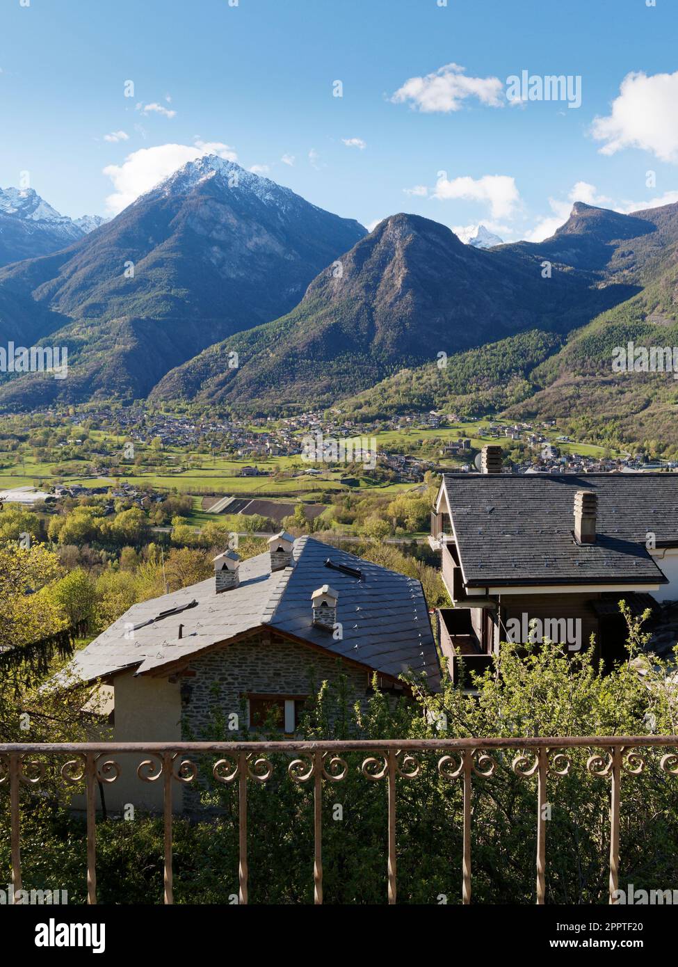 Overlooking the town of Fenis and its castle with mountains towering ...
