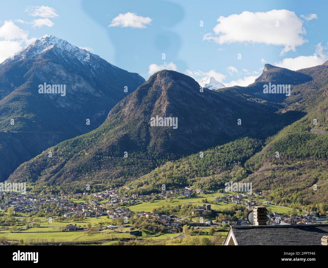Overlooking the town of Fenis and its castle with mountains towering ...
