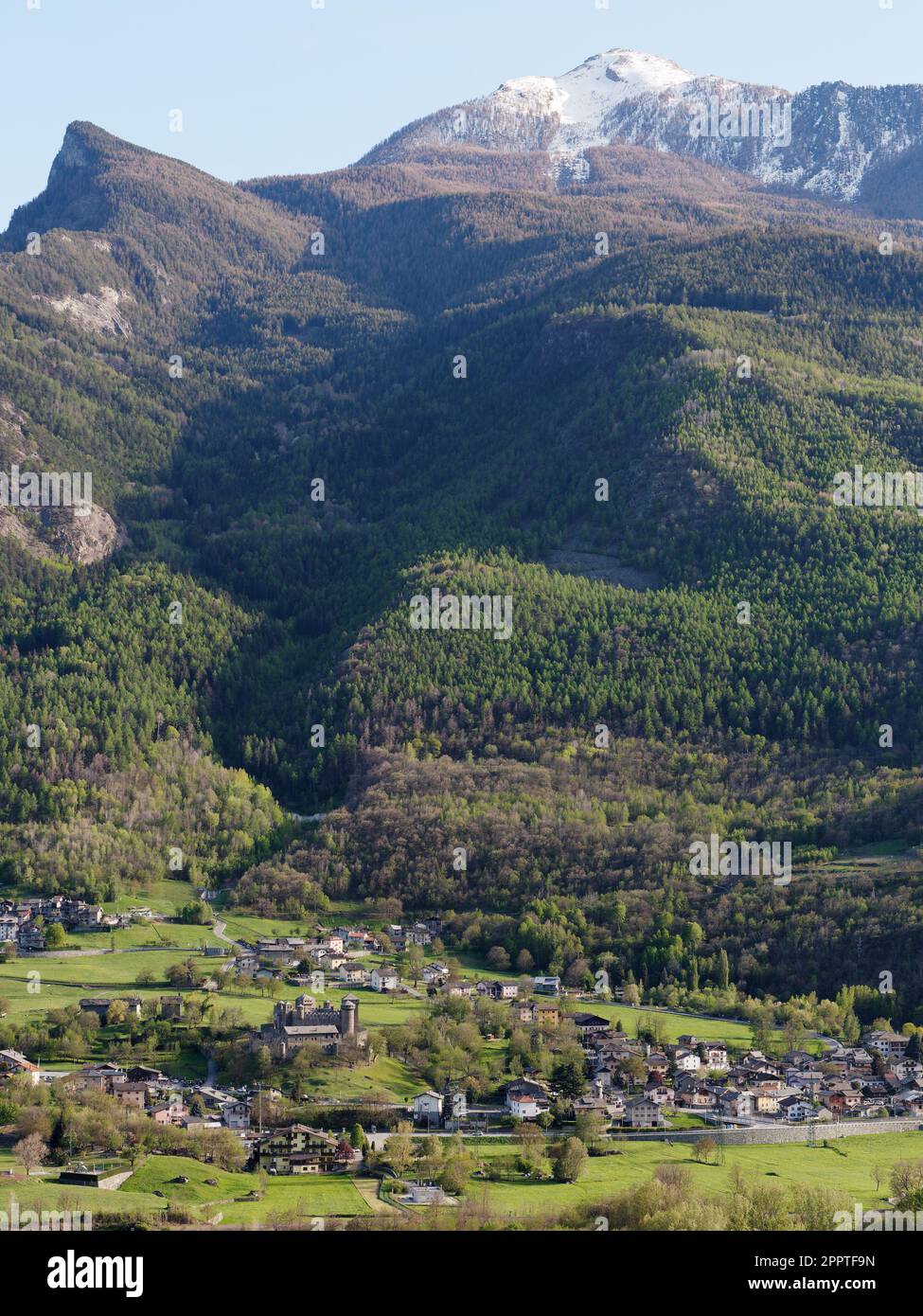 Overlooking the town of Fenis and its castle with mountains towering ...