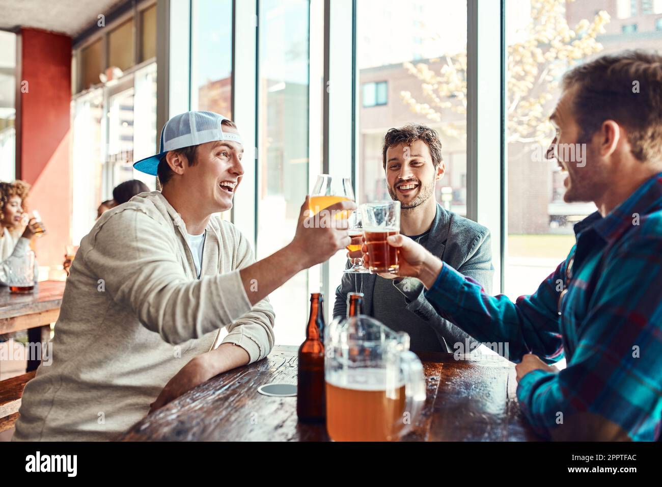 Group beer inside drinking cheers hi-res stock photography and images ...