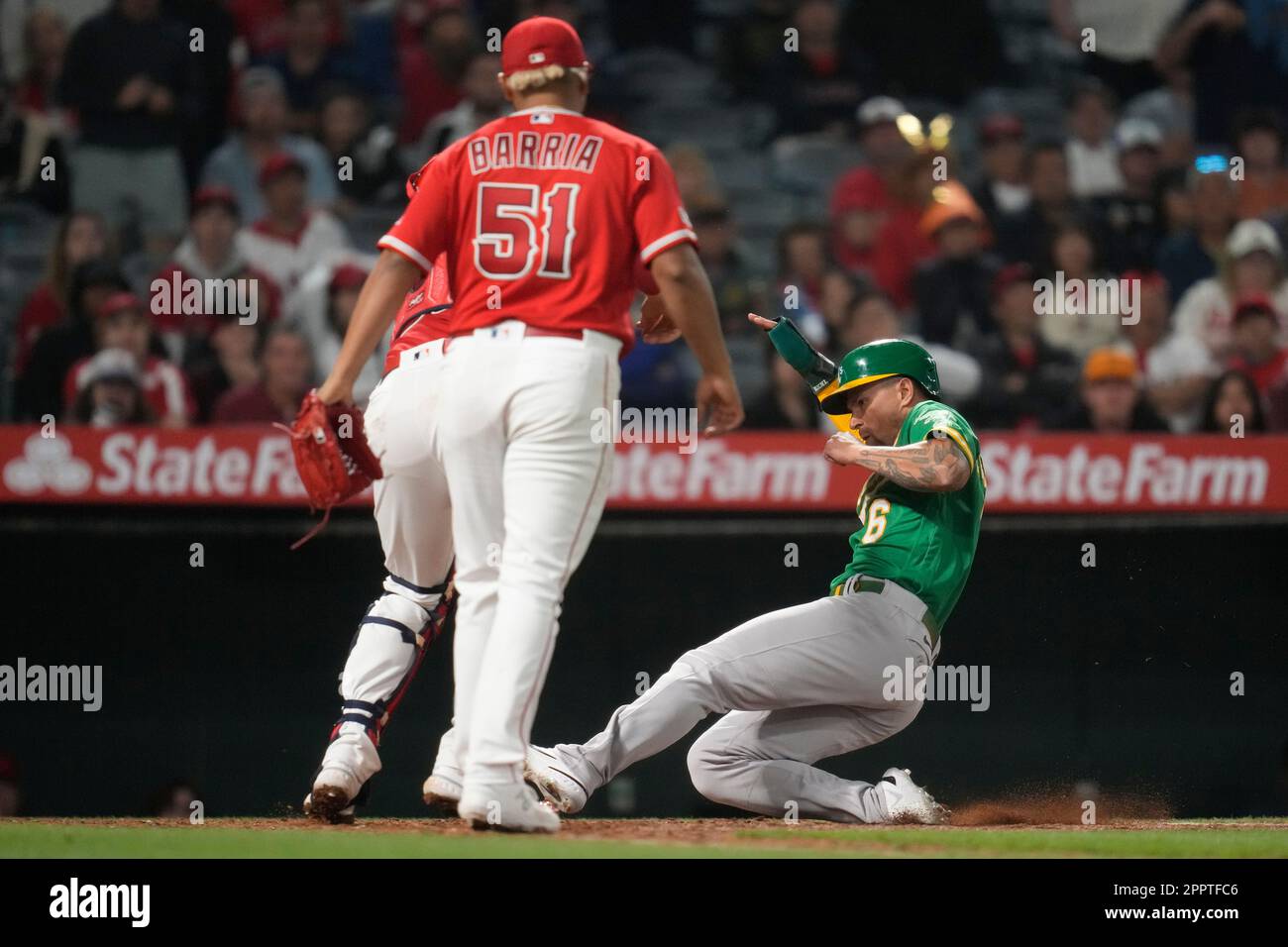 Oakland Athletics' Jace Peterson (6) scores ahead of tag by Los Angeles ...