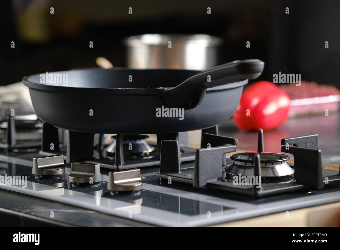 Low angle view of frying pan on a modern gas stove Stock Photo - Alamy