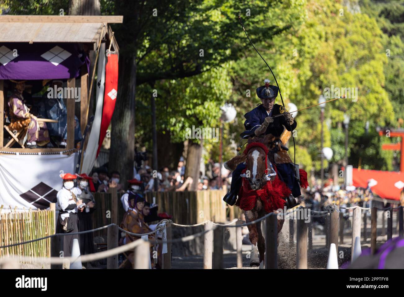 Yabusame (Japanese horseback archery) archer prepares his arrow to ...