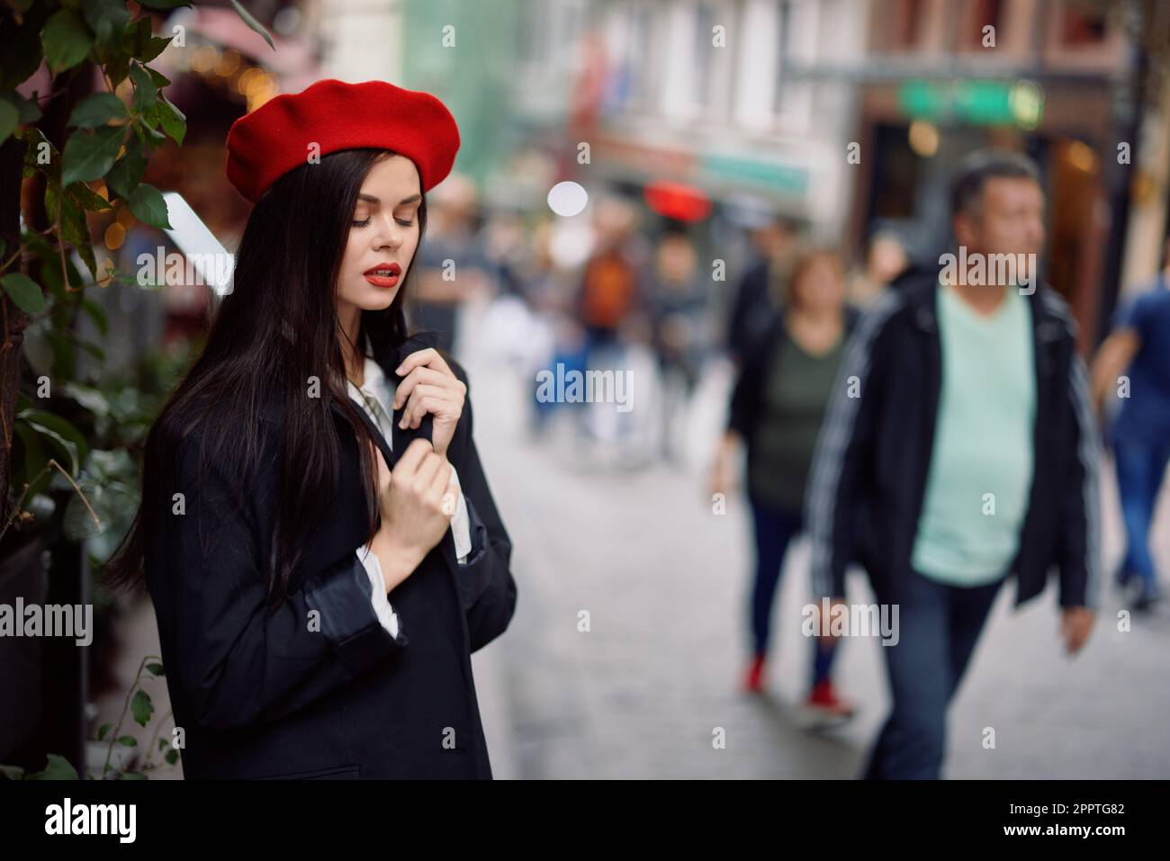 Woman walking down an old city street in a crowd, sociophobia, fear of ...