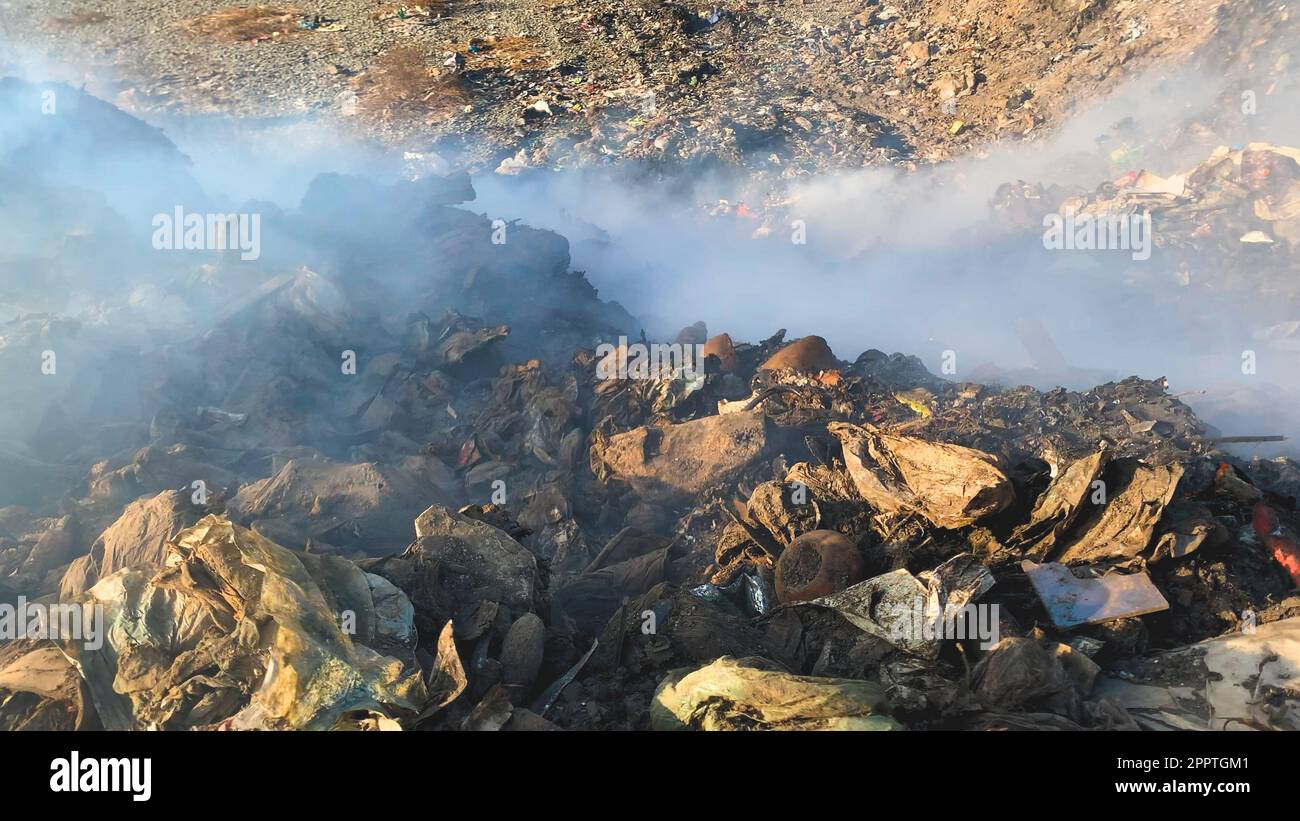 Burning pile of garbage at dump ground or landfill releasing toxic ...