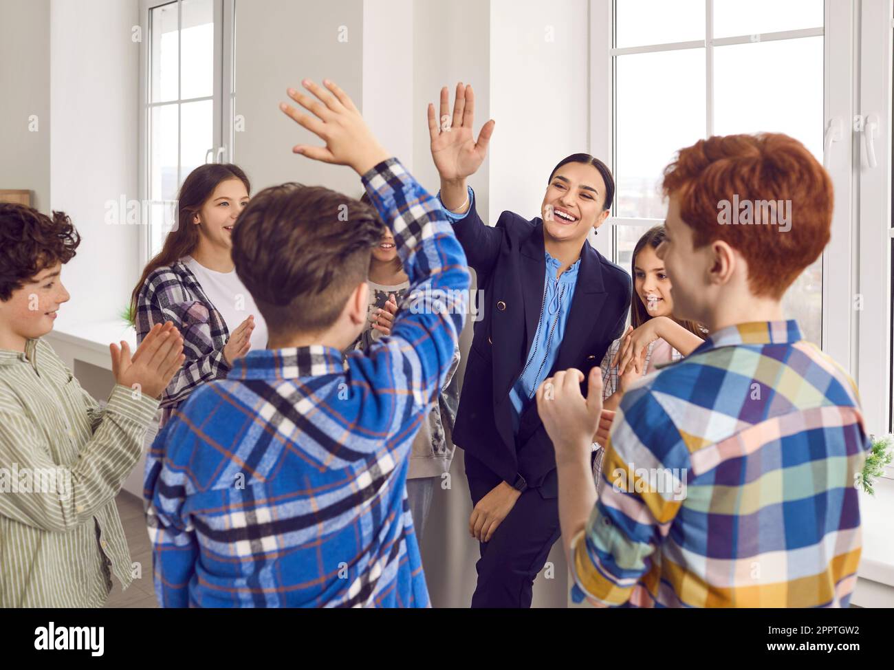Group of children and their teacher having fun and learning what ...