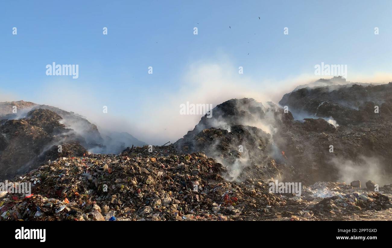 Burning pile of garbage at dump ground or landfill releasing toxic ...