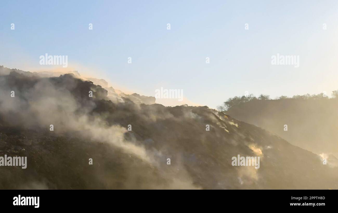 Burning pile of garbage at dump ground or landfill releasing toxic ...