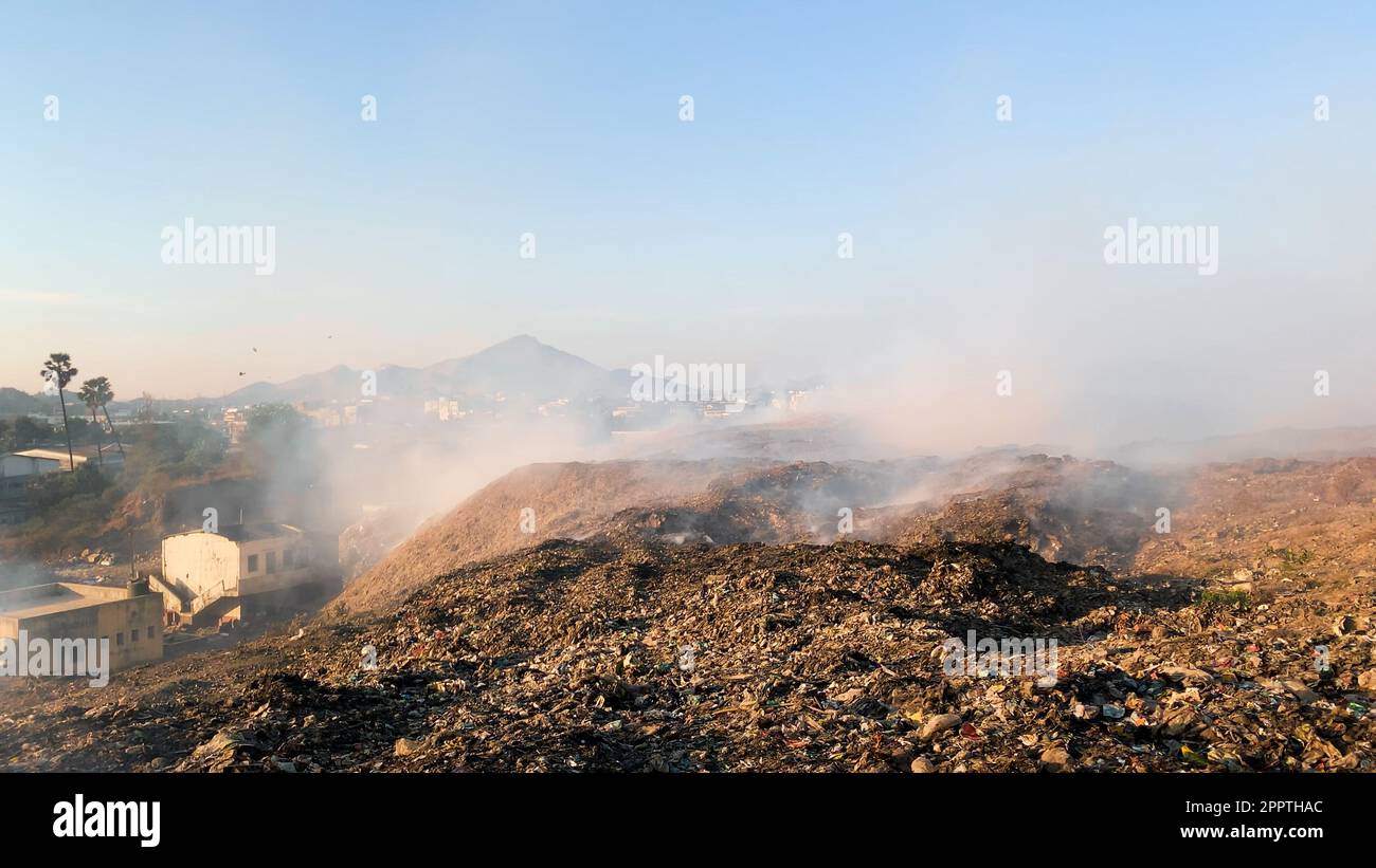 Burning pile of garbage at dump ground or landfill releasing toxic ...