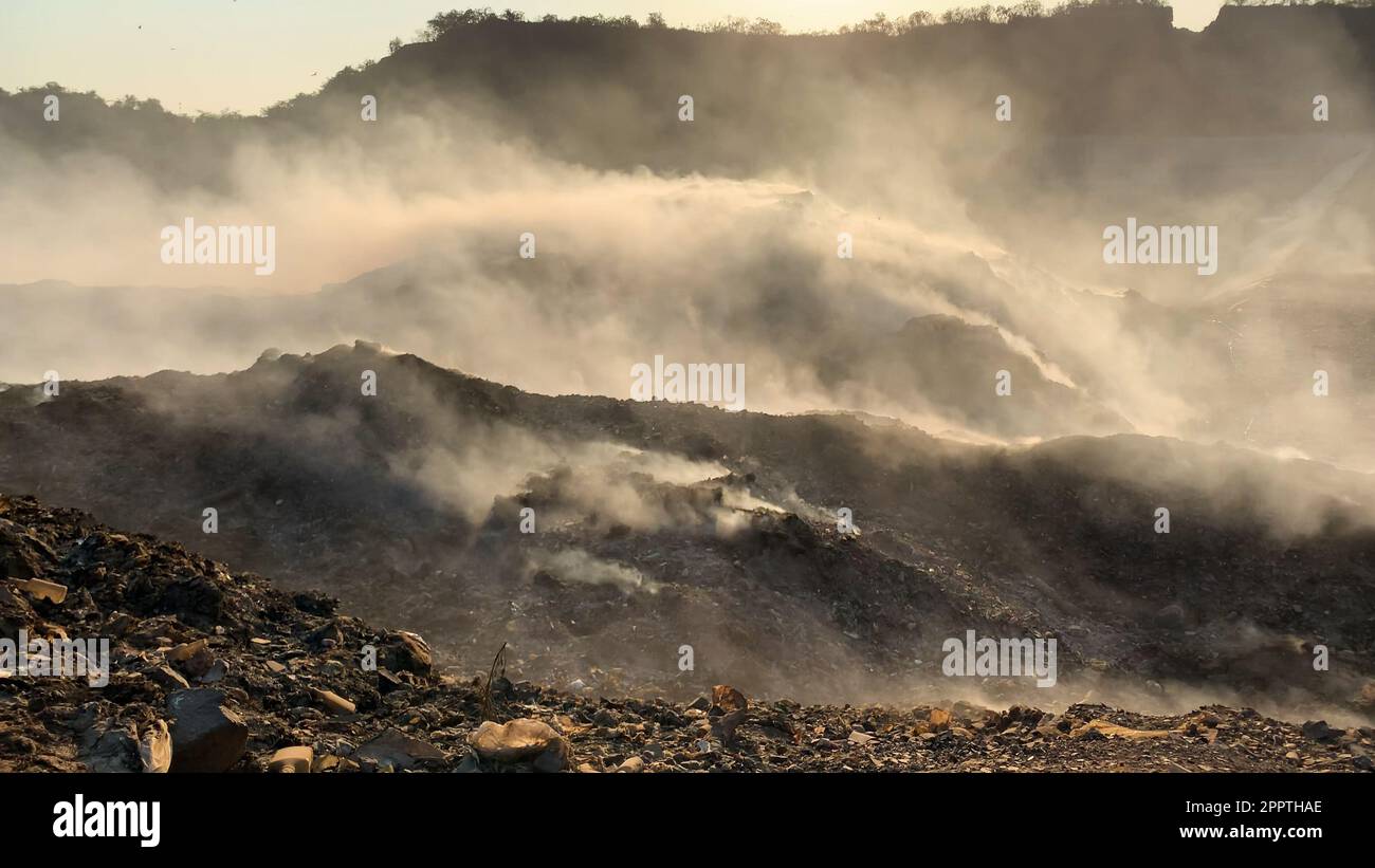 Burning pile of garbage at dump ground or landfill releasing toxic ...