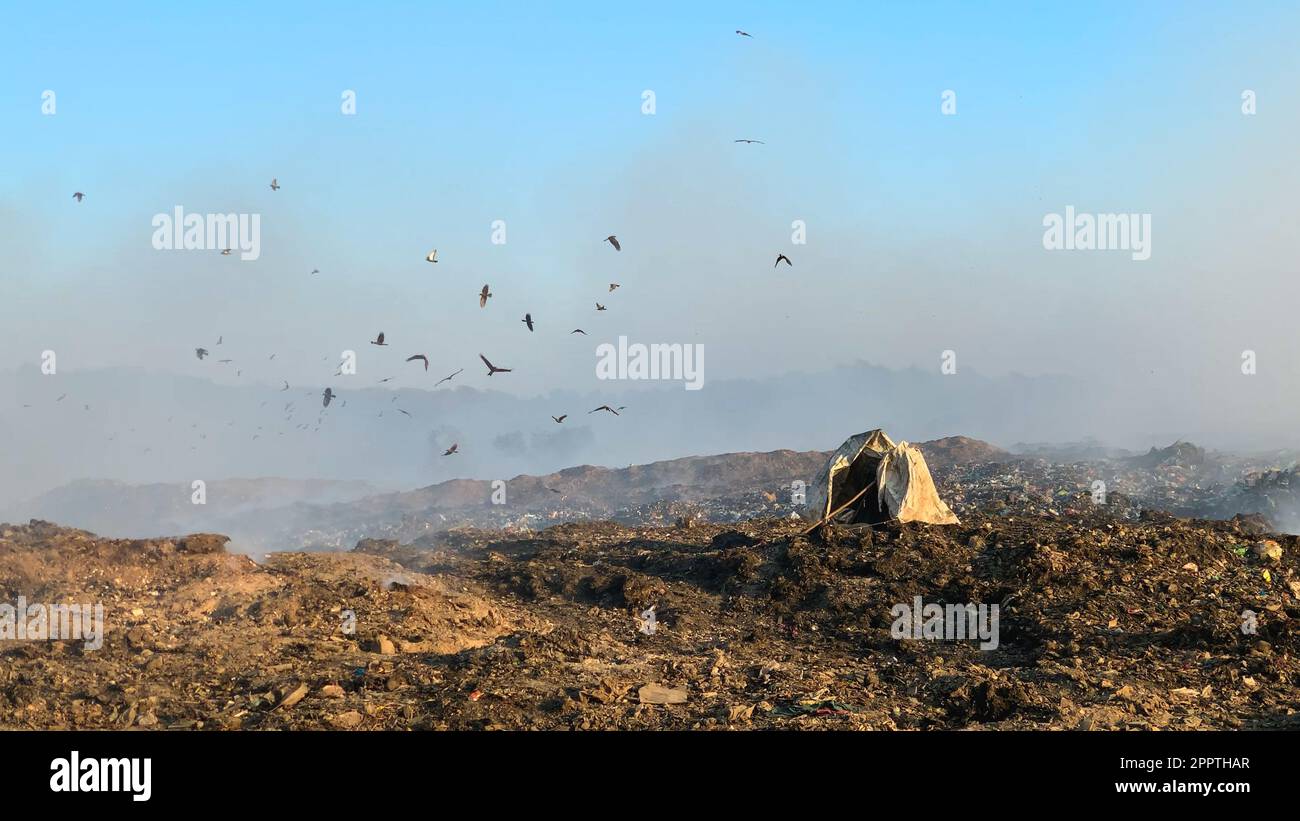 Burning pile of garbage at dump ground or landfill releasing toxic ...