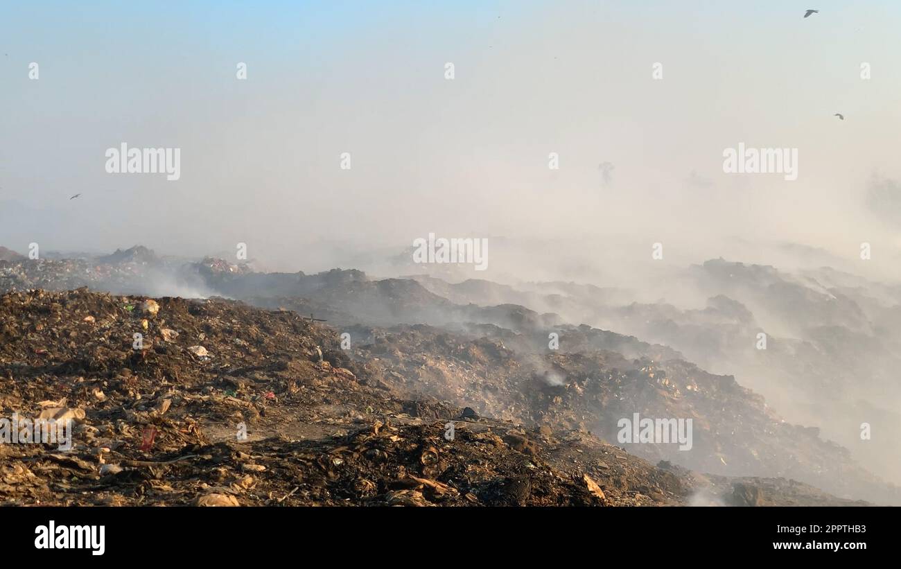 Burning pile of garbage at dump ground or landfill releasing toxic ...