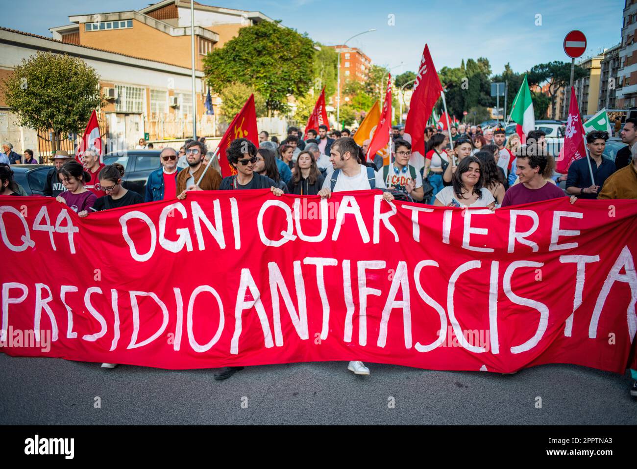 Protesters hold a banner that says 'Q44 every neighborhood anti-fascist ...