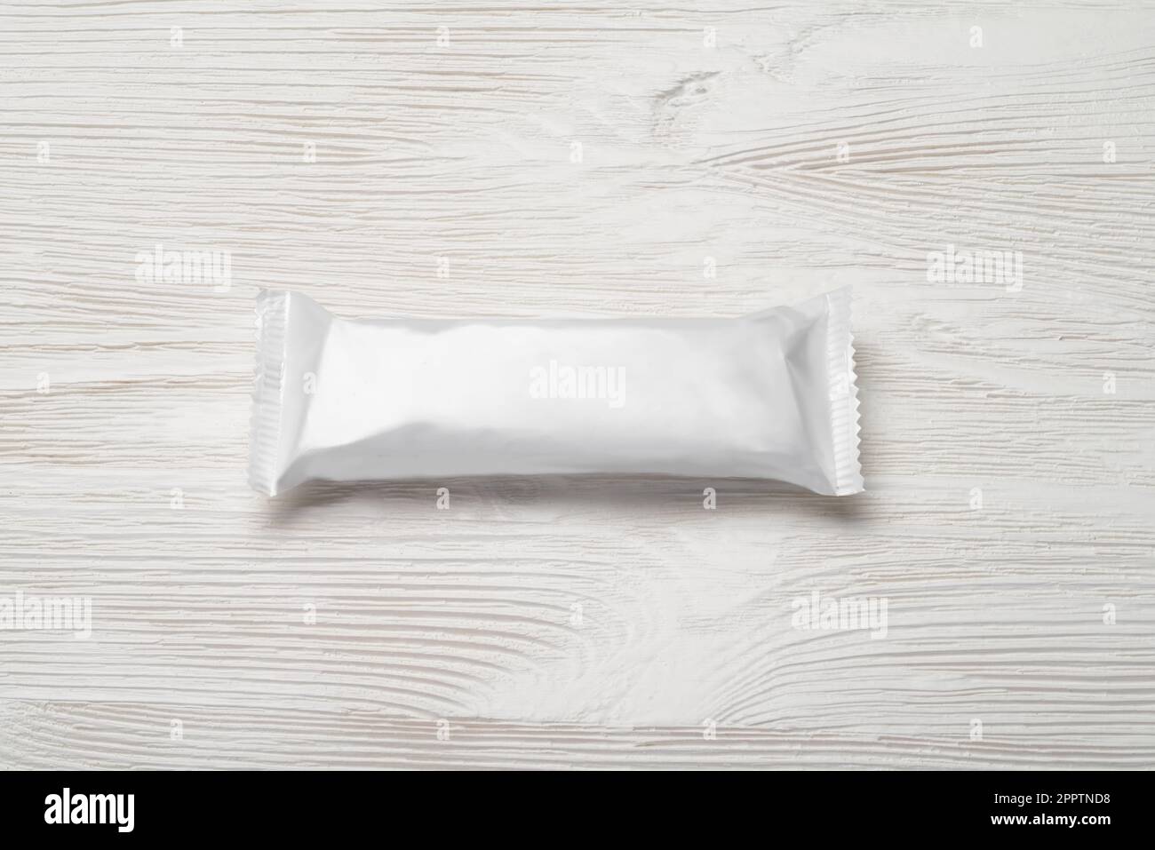 White blank chocolate bar package on the wood table. Mock-up template ...
