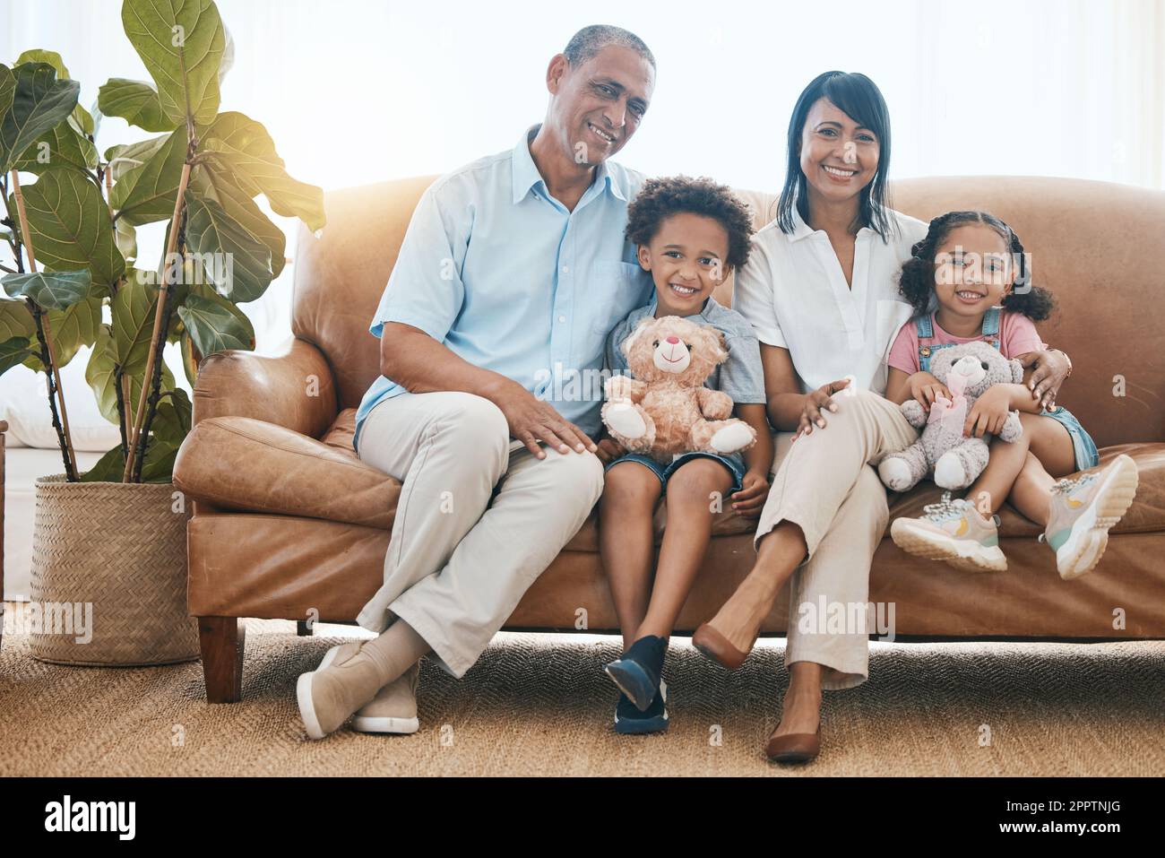 Grandparents, portrait and kids smile in home living room on sofa ...