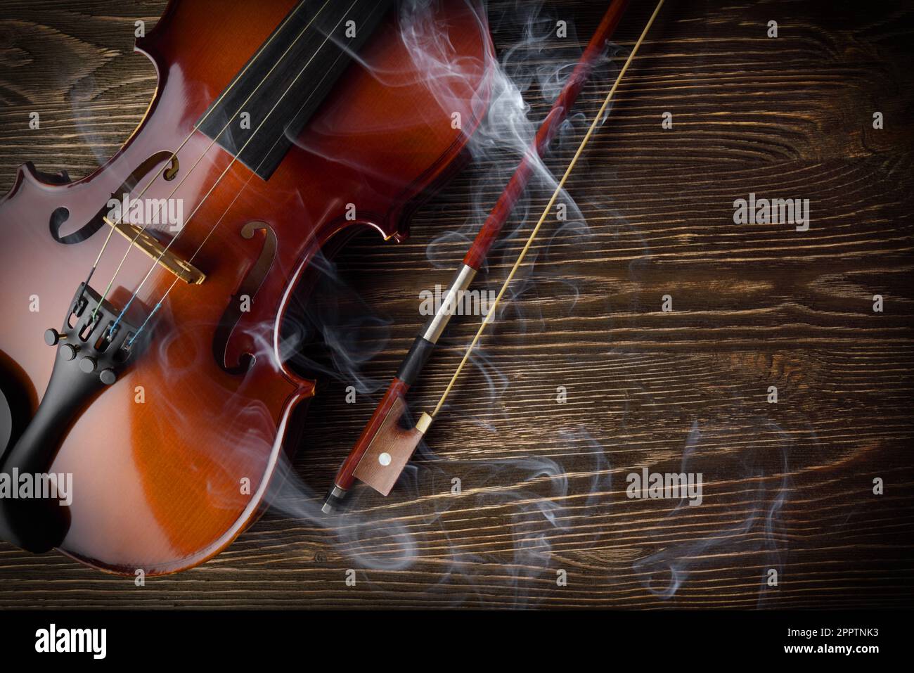 Violin with bow on brown wooden table with copy space, top view Stock ...