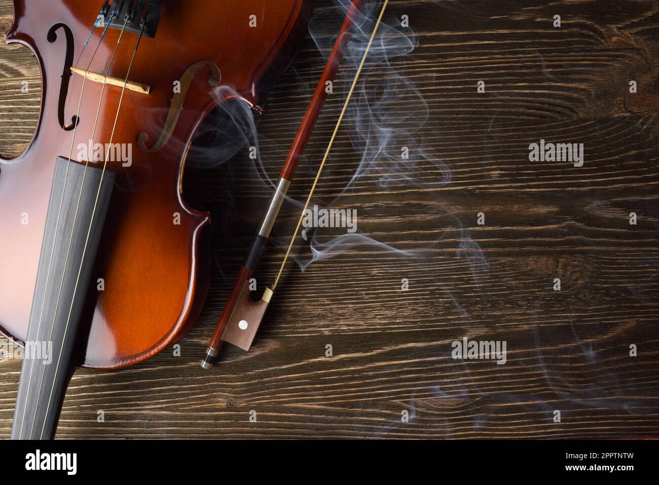 Violin with bow on brown wooden table with copy space, top view Stock ...