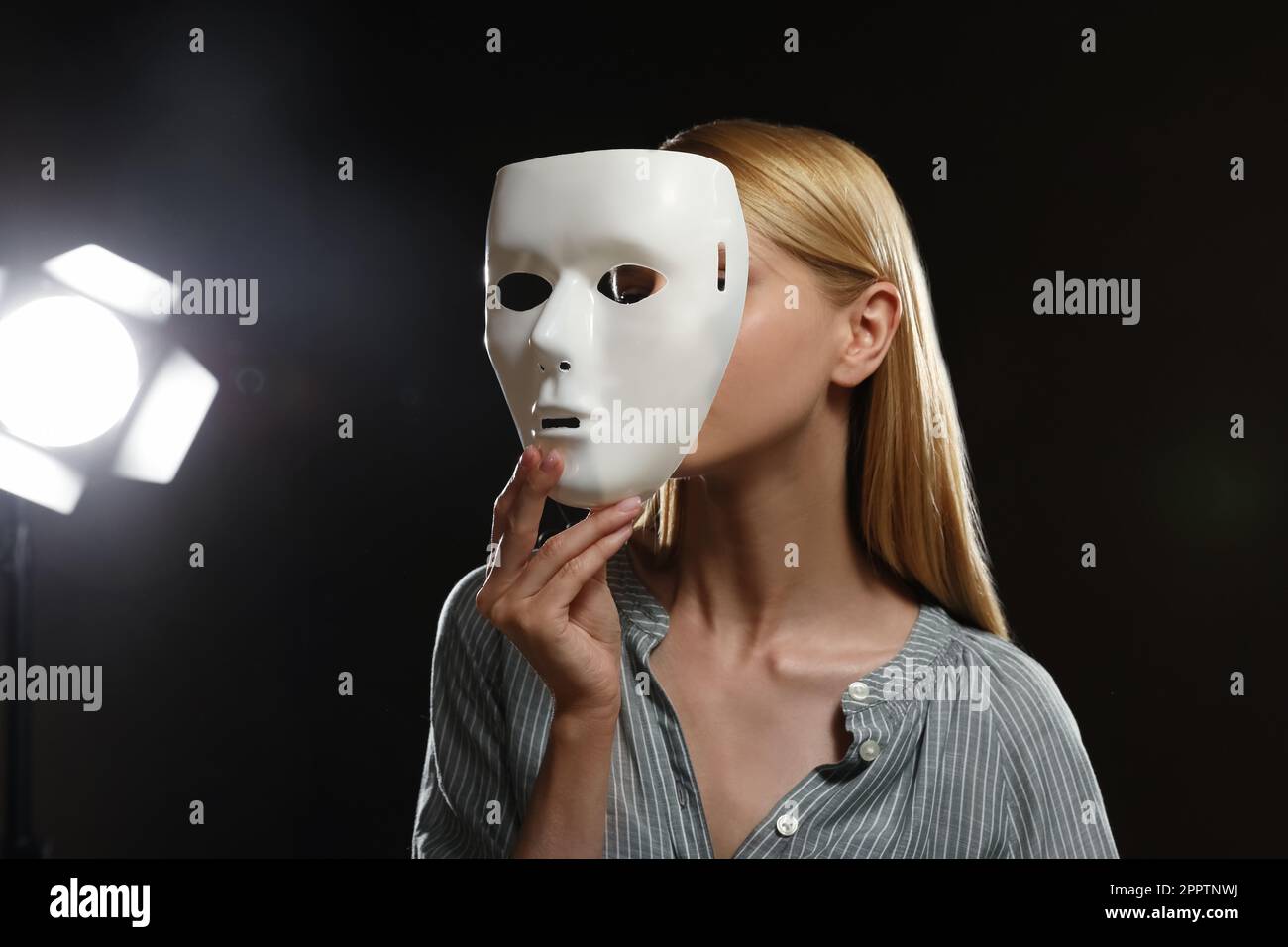 Professional actress with mask on stage in theatre Stock Photo - Alamy