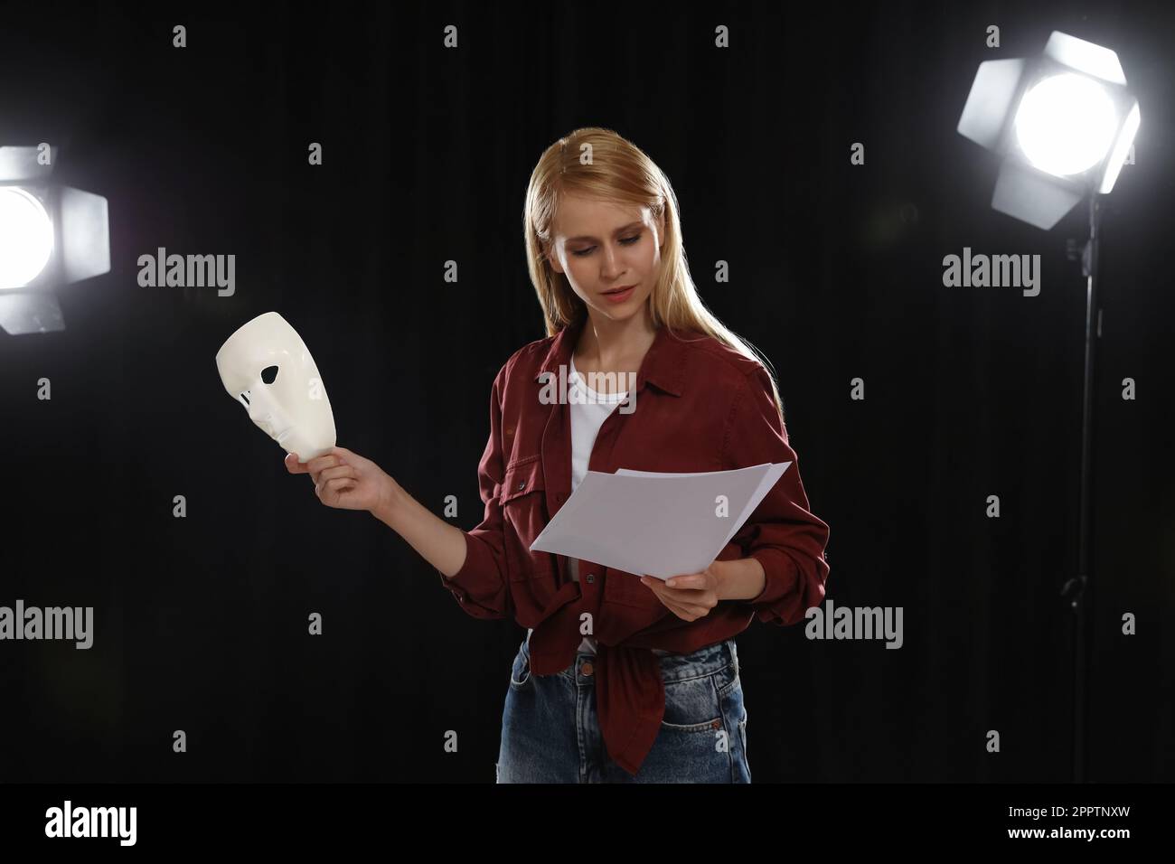 Professional actress reading her script during rehearsal in theatre ...