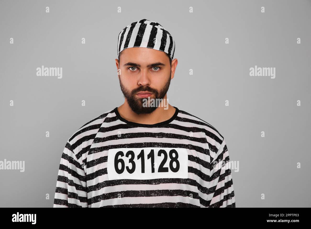 Prisoner in special uniform on grey background Stock Photo - Alamy