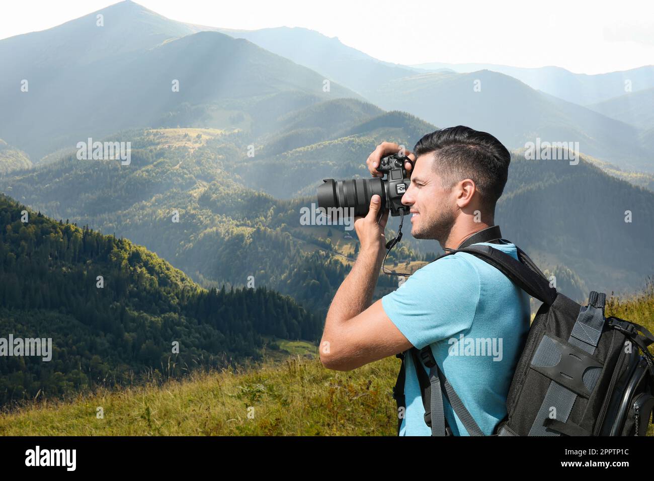 Photographer taking picture of beautiful mountains with professional ...