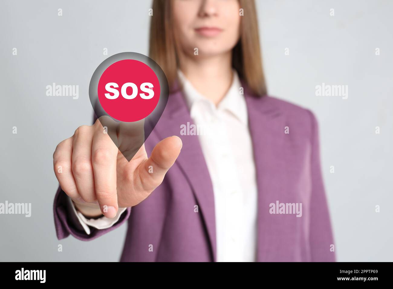 Young woman pressing virtual SOS button in case of danger on grey ...