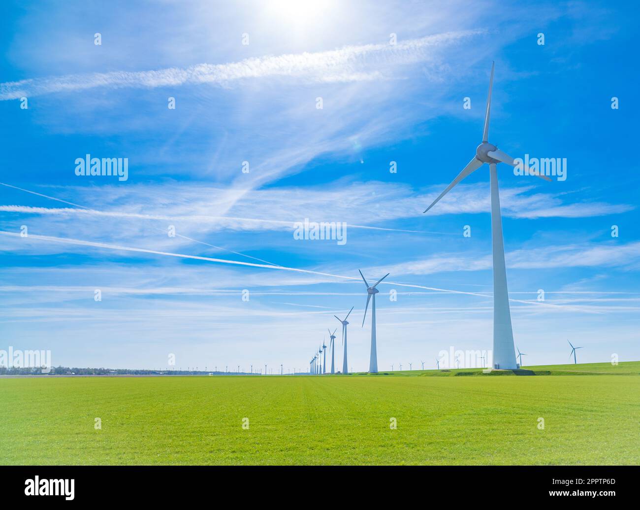 row of windmills in a flat dutch landscape Stock Photo - Alamy